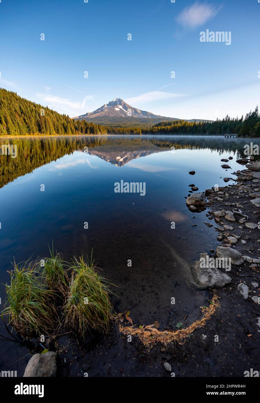 Lake shore, reflection of Mt. Hood volcano in Trillium Lake, in morning ...