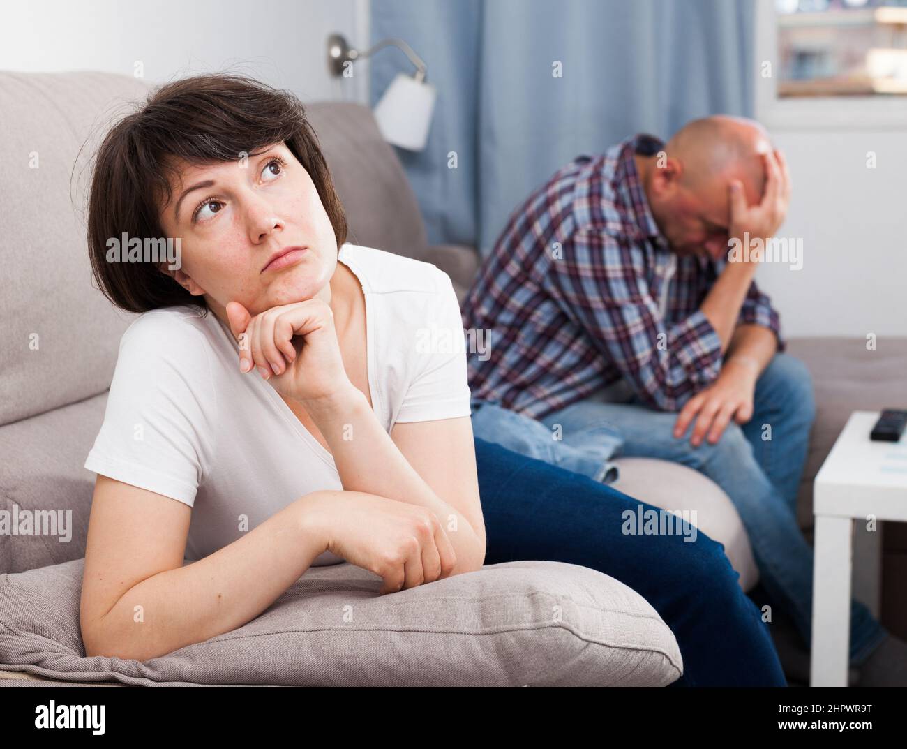 Sad family having difficulties in the living room at home Stock Photo ...