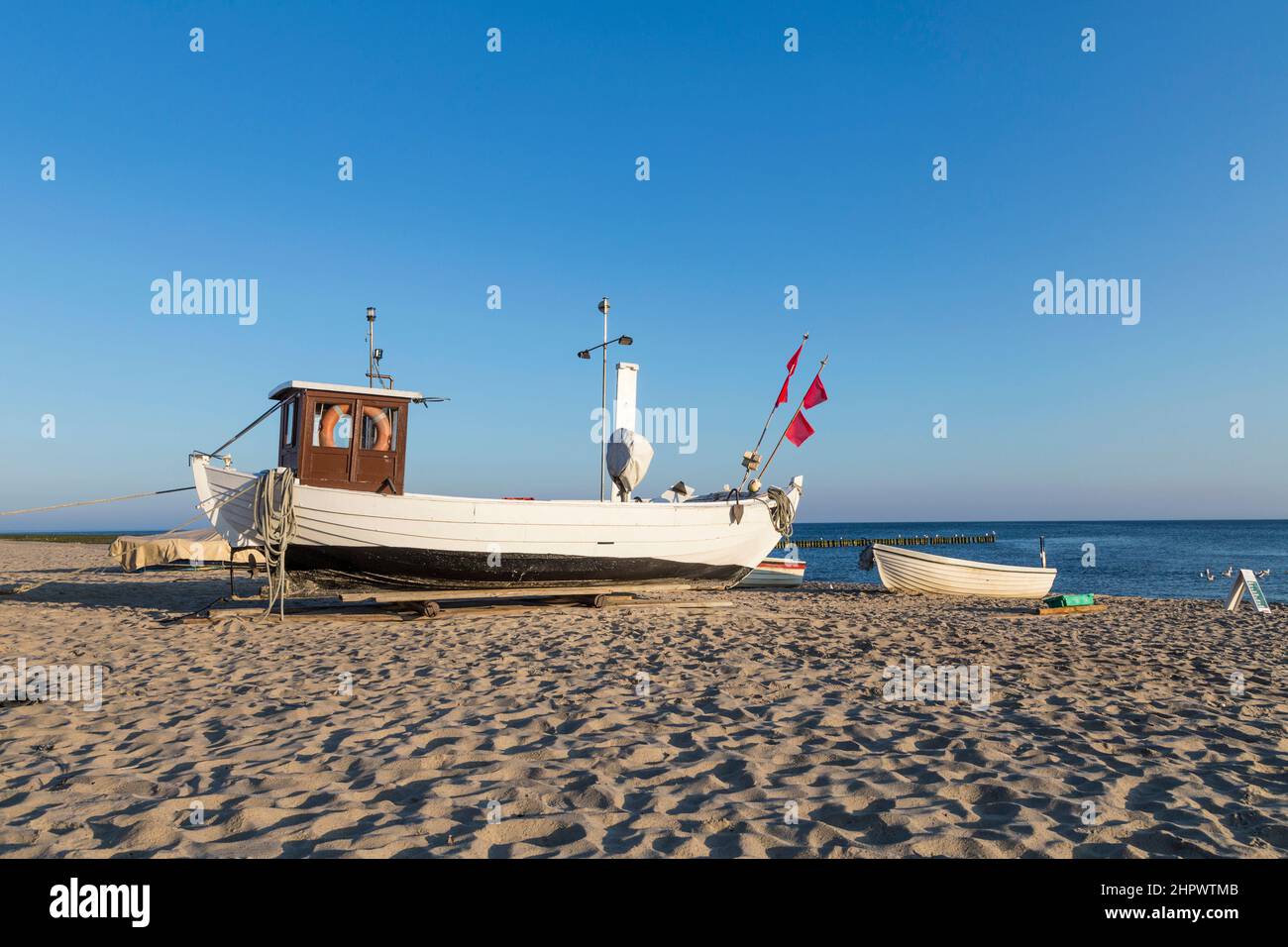 A fishing boat on shore of the Baltic Sea in Koserow, Germany Stock ...