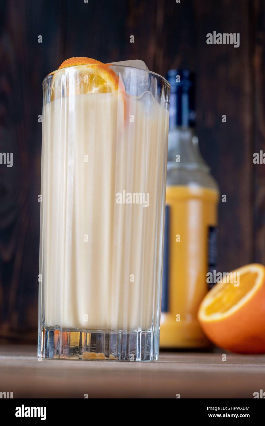 Glass of Bessie and Jessie Cocktail garnished with orange slice wheel ...