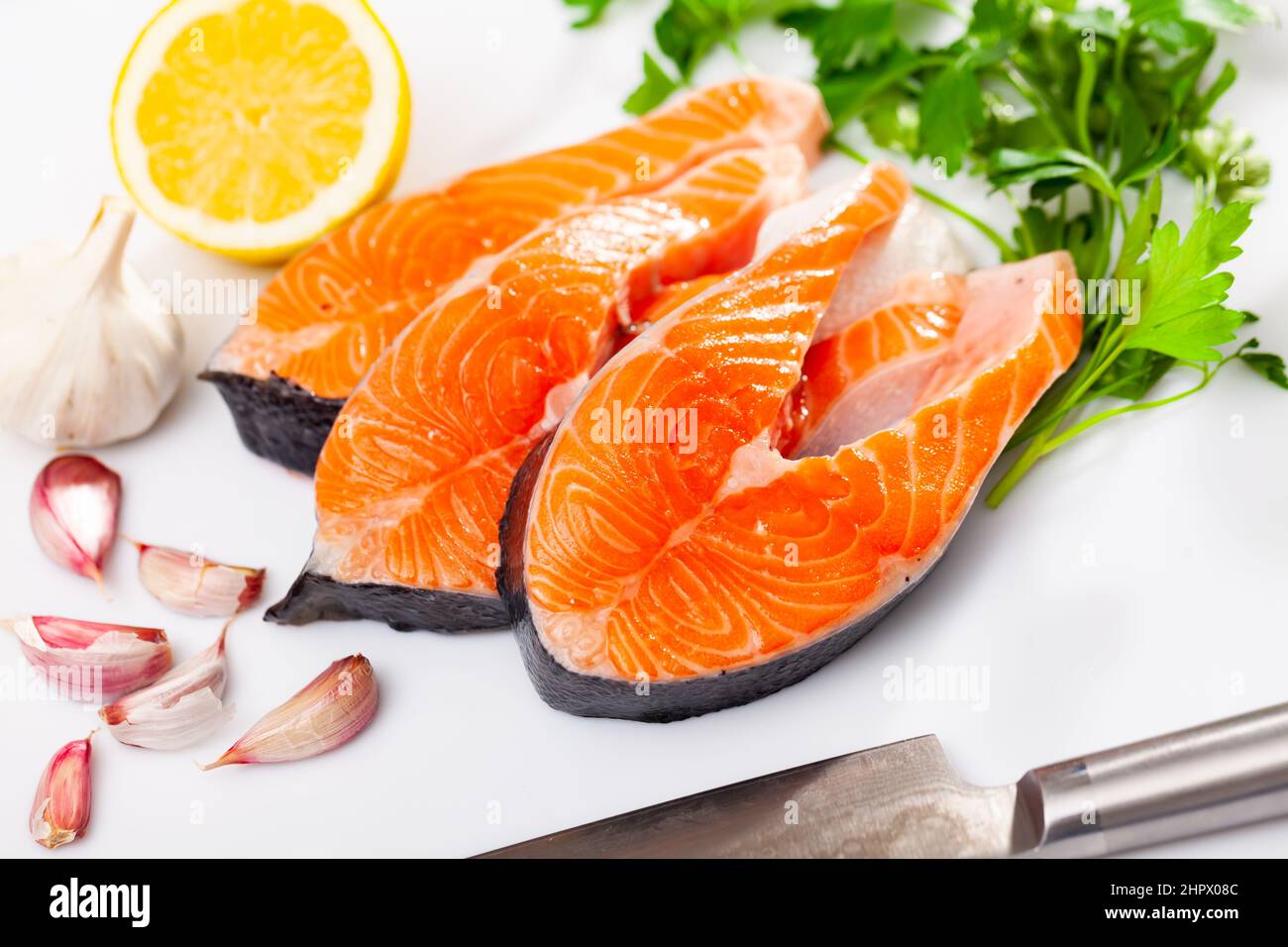 Raw salmon steaks, over white background Stock Photo - Alamy