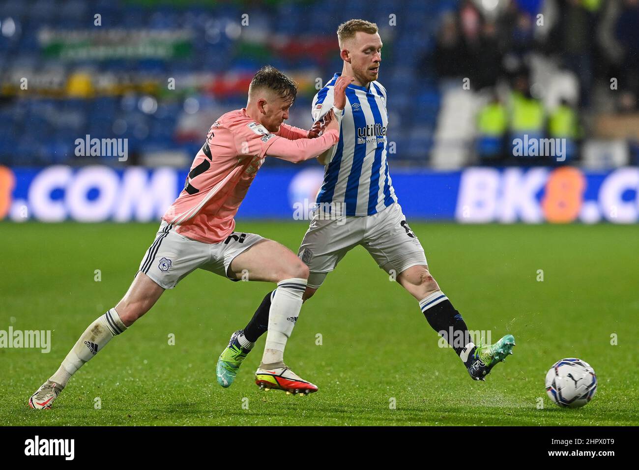 Lewis O'Brien #8 of Huddersfield Town passes the ball despite the ...