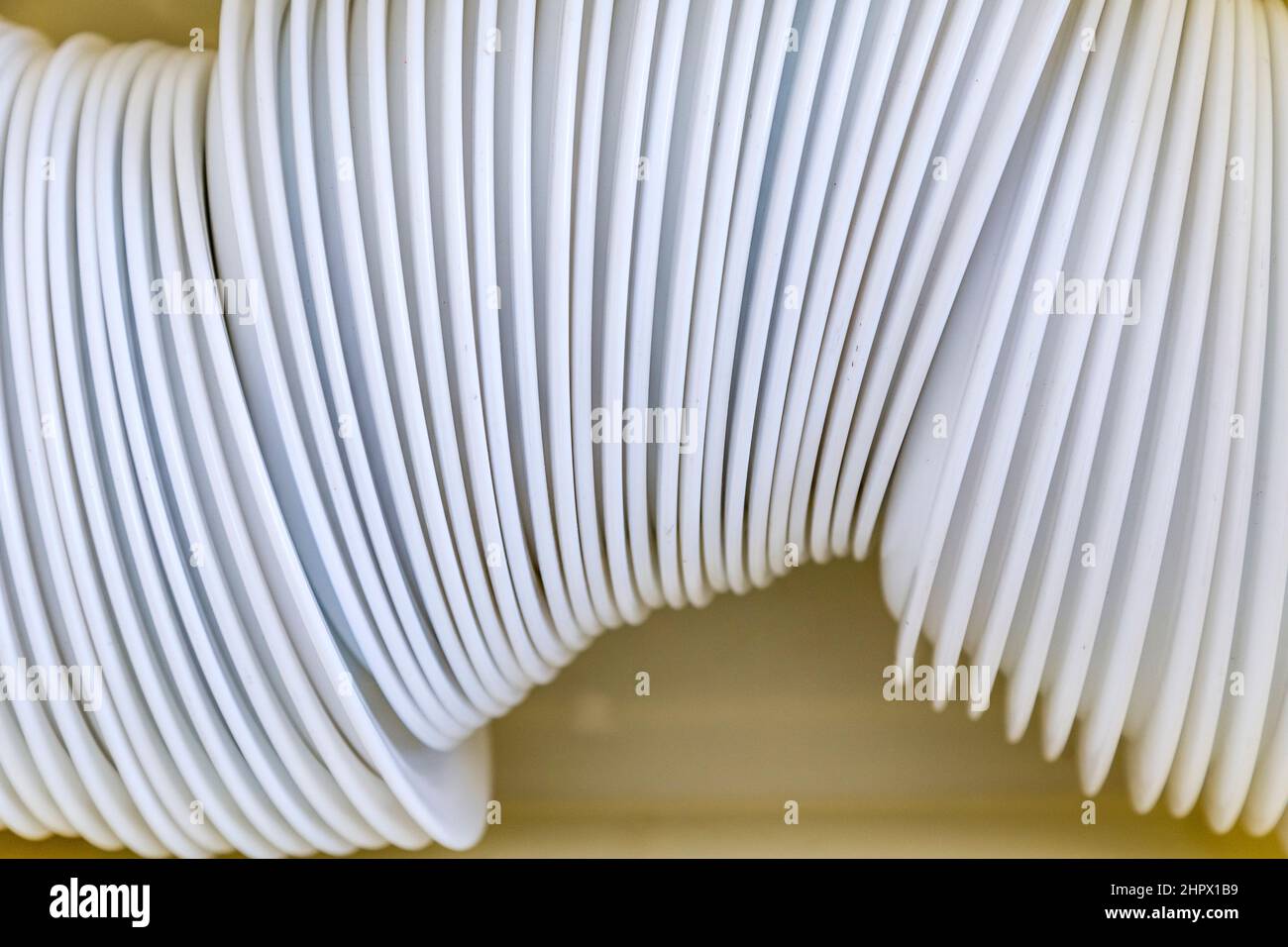 many white plates stapled in a boy Stock Photo - Alamy