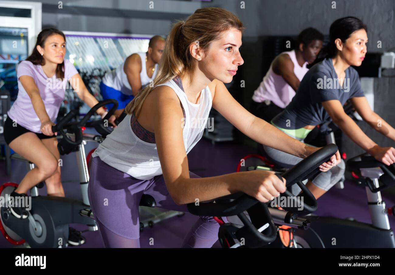 Female cycling on exercise bikes at fitness club Stock Photo - Alamy