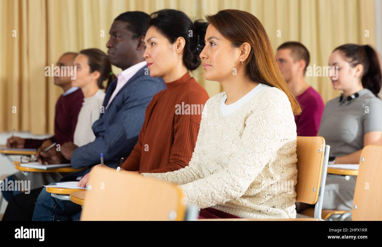 Students listening task for exam in classroom Stock Photo - Alamy