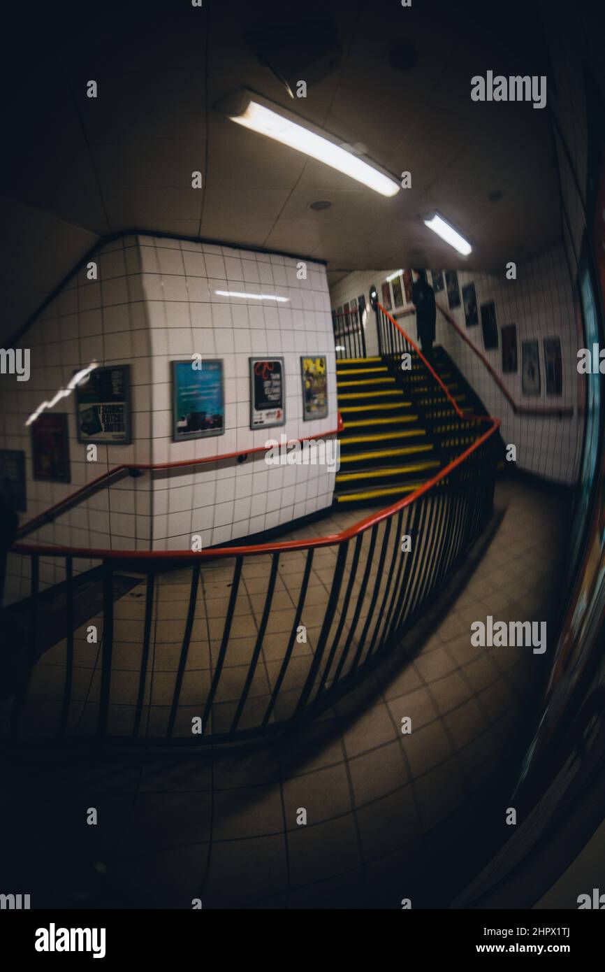 Vertical fish-eye view of a train station stairway lined with framed ...