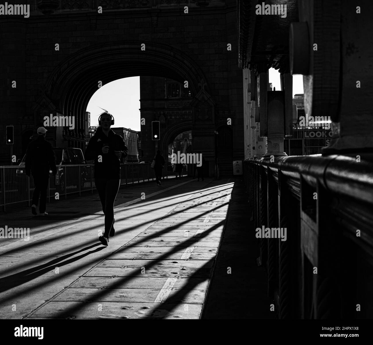 Grayscale of a person running on Tower Bridge, London Stock Photo - Alamy
