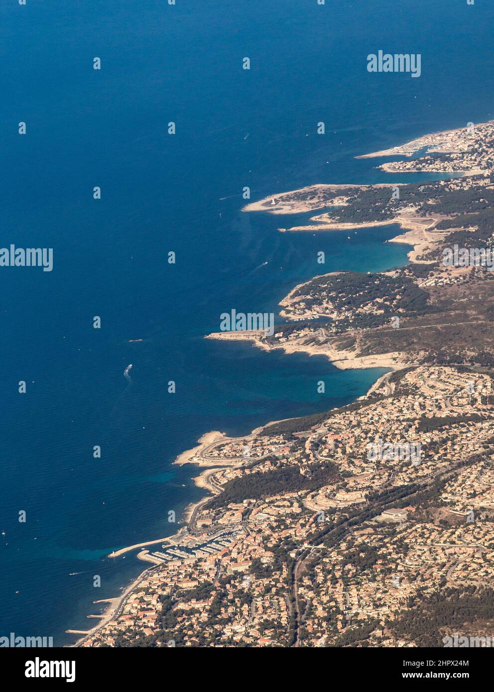 mediterranean coastal aerial near Marseille with harbor under blue sky ...
