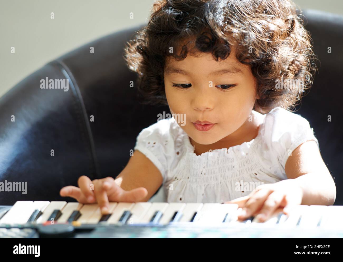 Learning as she grows. Shot of a cute little girl at home Stock Photo ...
