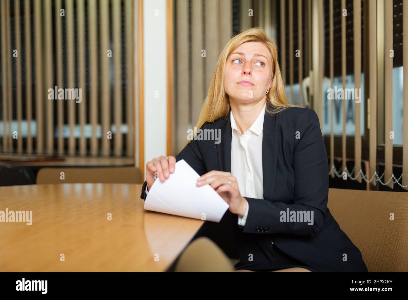 Upset female writing resignation letter Stock Photo - Alamy