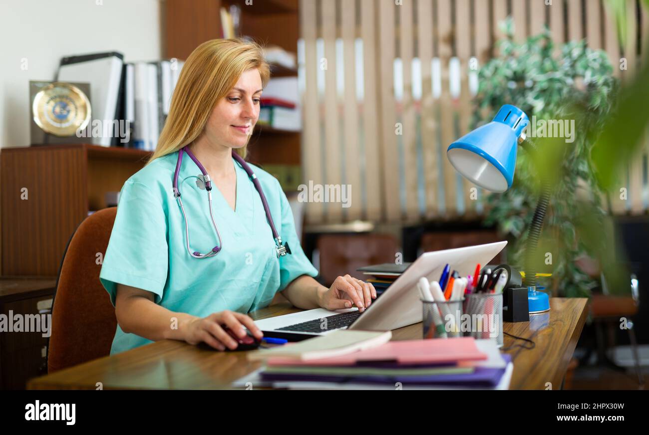 Doctor works in front of computers in private clinic Stock Photo - Alamy