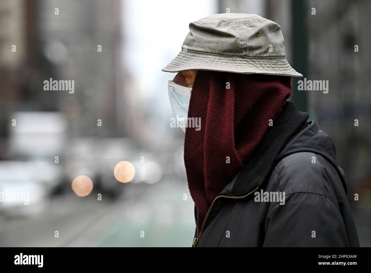 New York, USA. 23rd Feb, 2022. A man waiting at a crosswalk in Herald ...