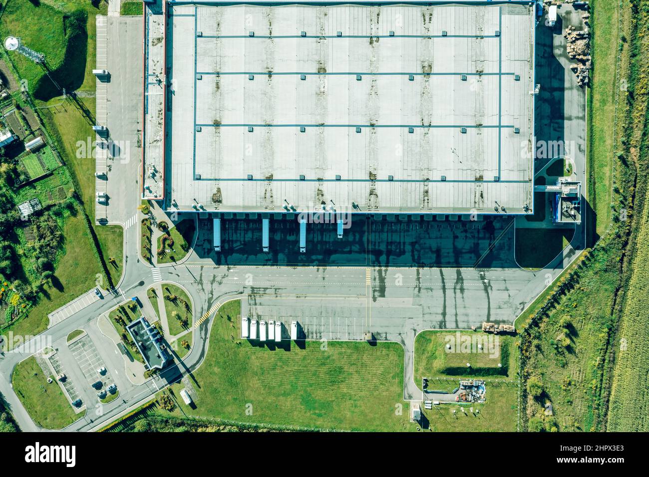 modern storage warehouse with trucks on parking lot. aerial view of ...