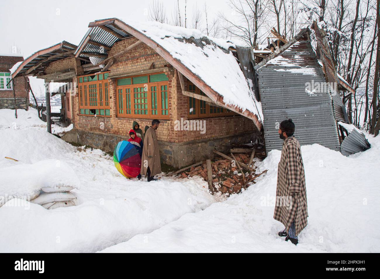 Budgam, India. 22nd Feb, 2022. People inspect a damaged of the house at ...