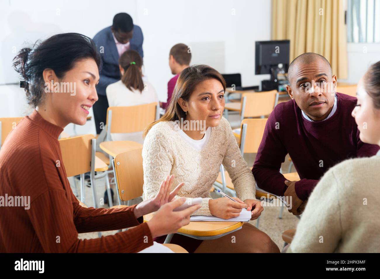 Adult students in cooperation with their school assignment Stock Photo ... Adult students in cooperation with their school assignment Stock Photo ...