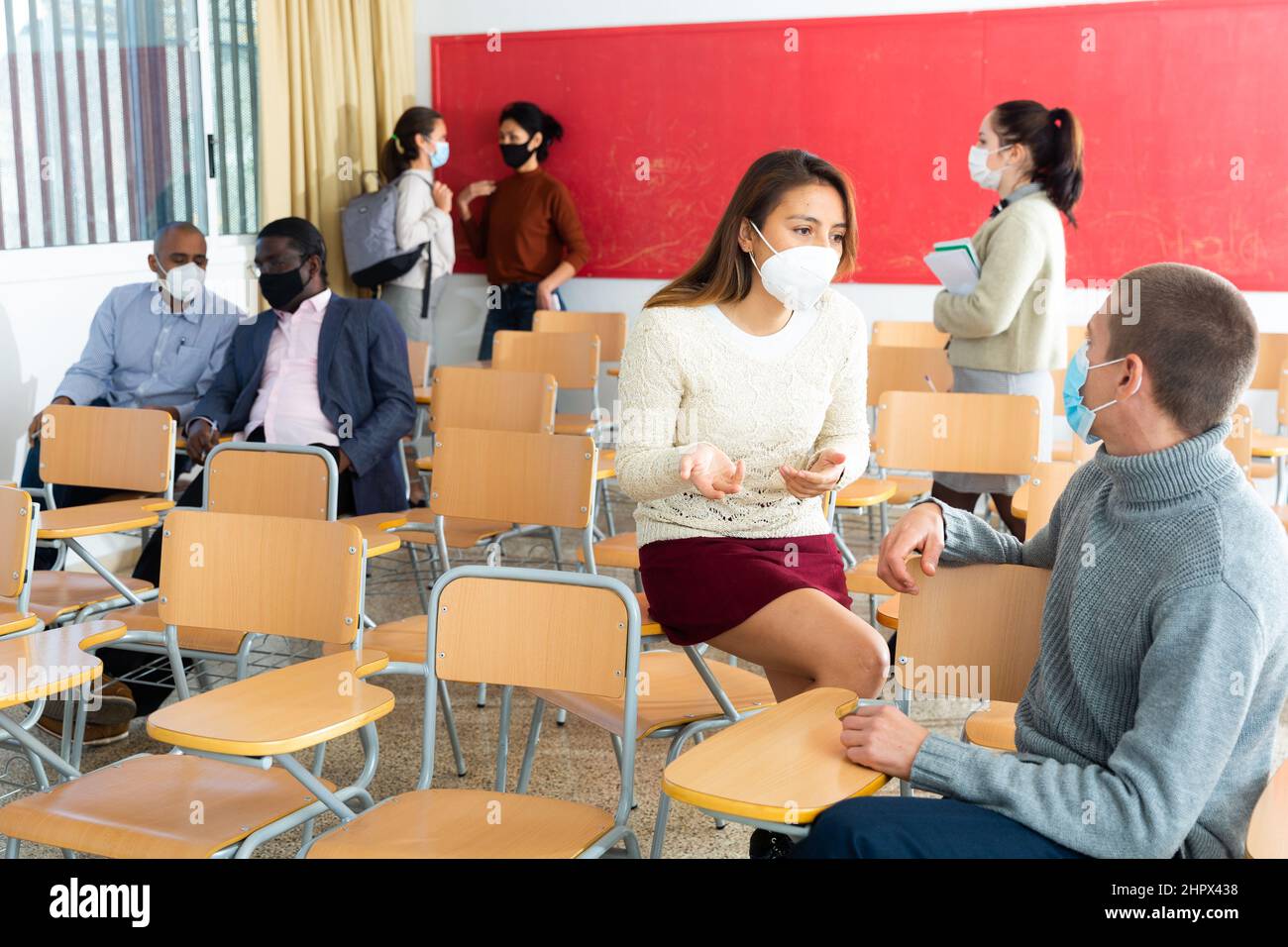 Latin american and caucasian students wearing face masks for prevention ...