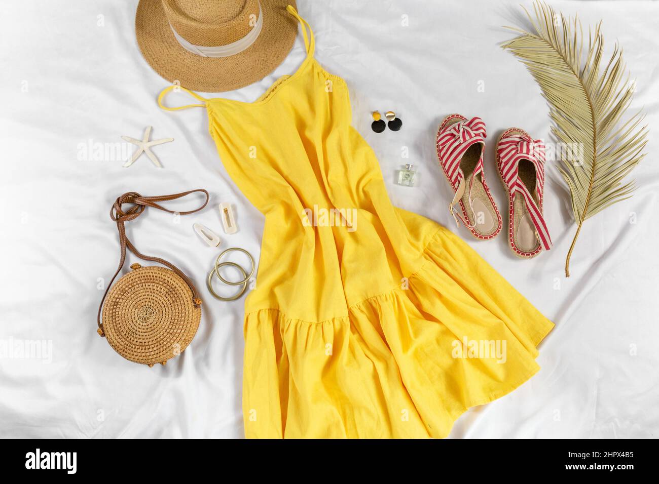 Straw hat, yellow dress, straw bag on white background. Trendy summer ...