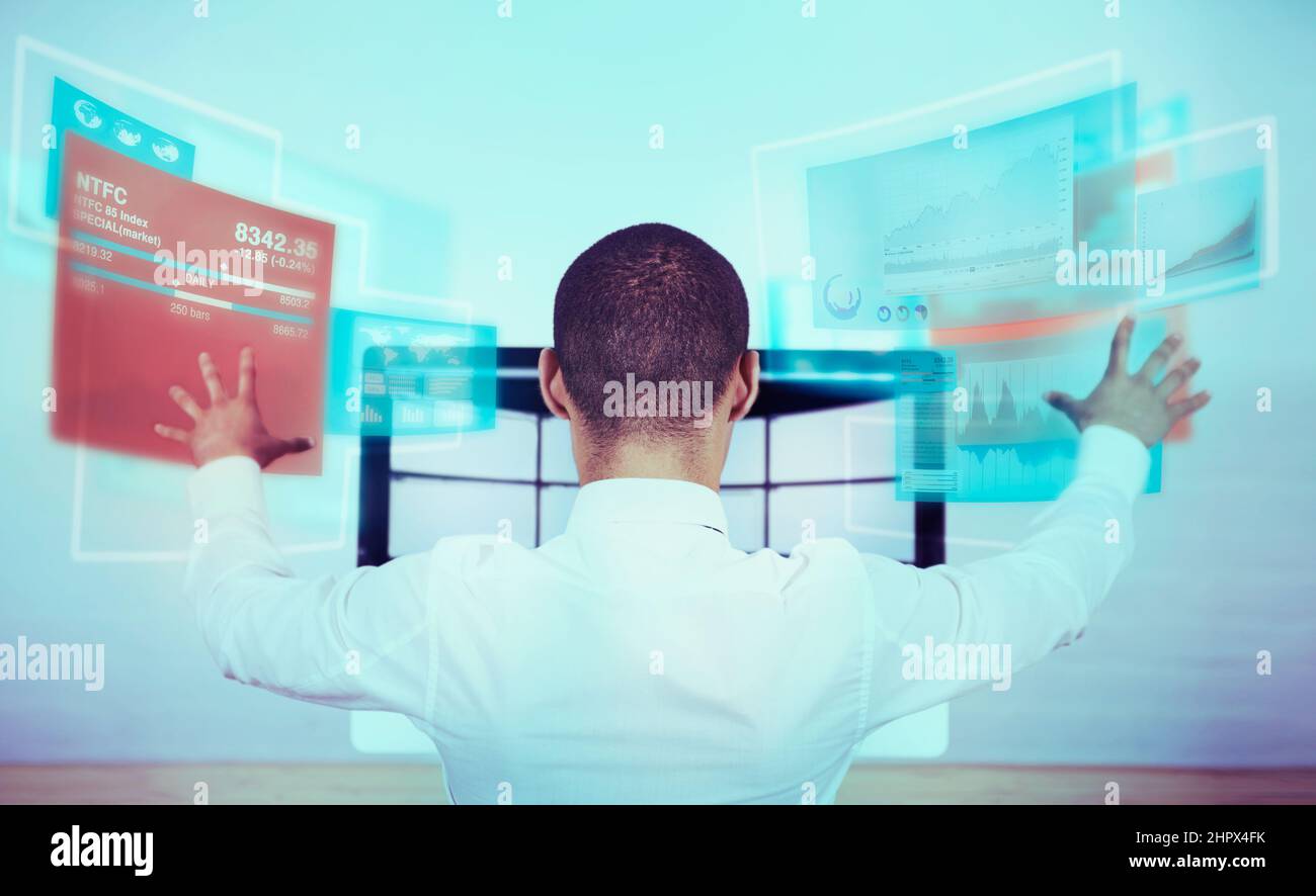 A rear view shot of a man using a futuristic computer. All screen ...