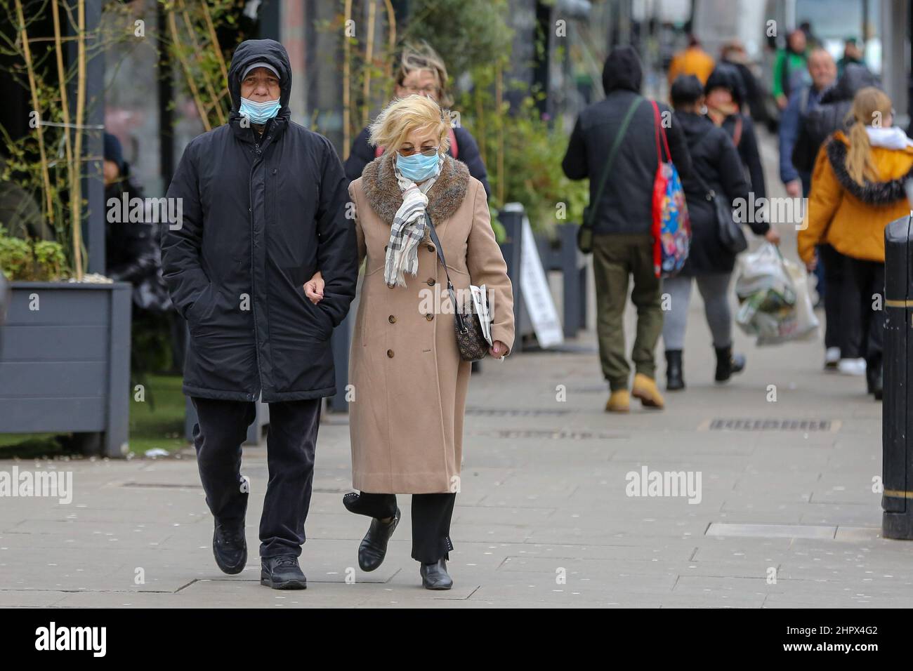 London, UK. 21st Feb, 2022. A couple wearing face masks as a preventive ...