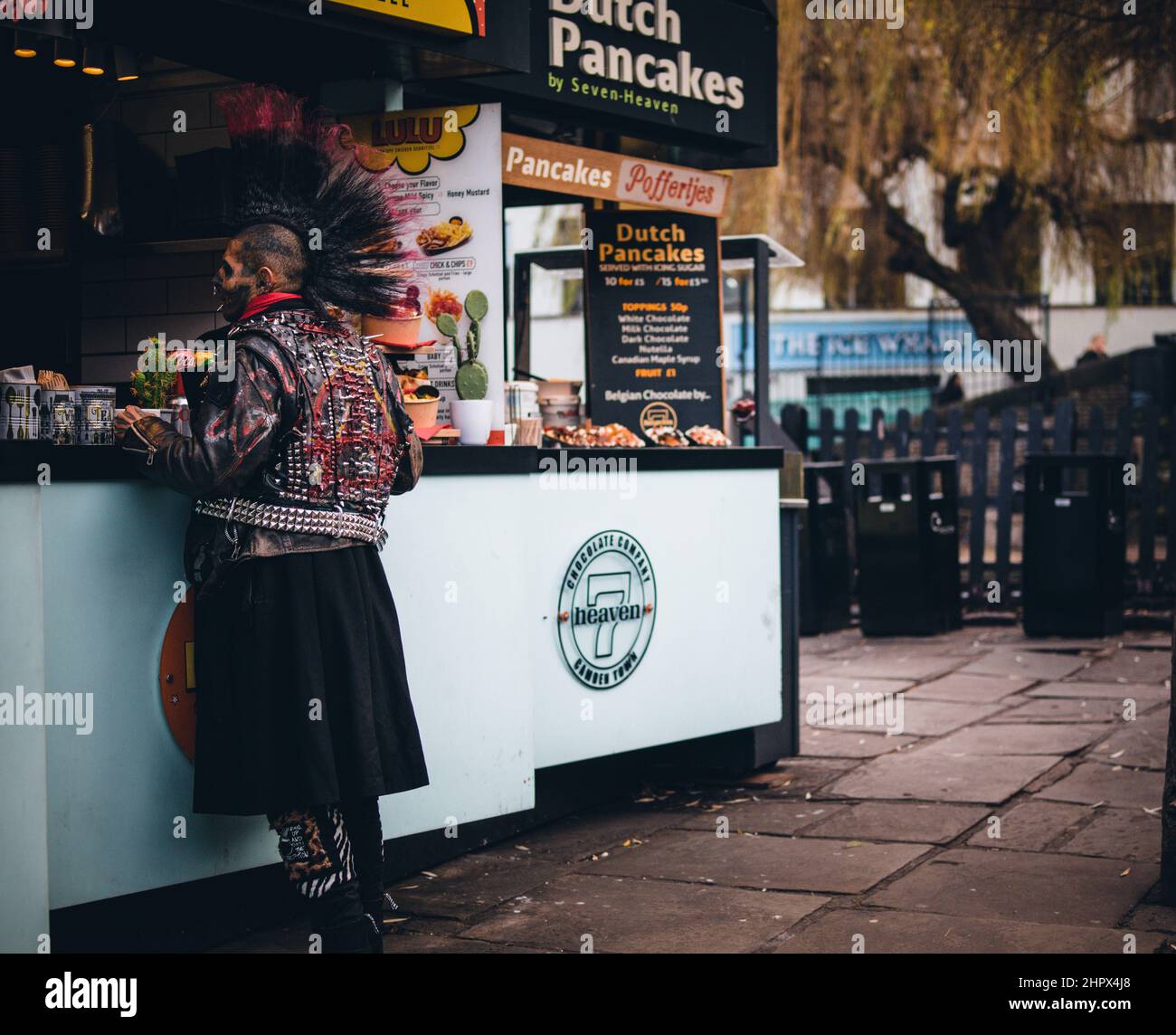 View of a punk man ordering food in Camden Town London Stock Photo - Alamy