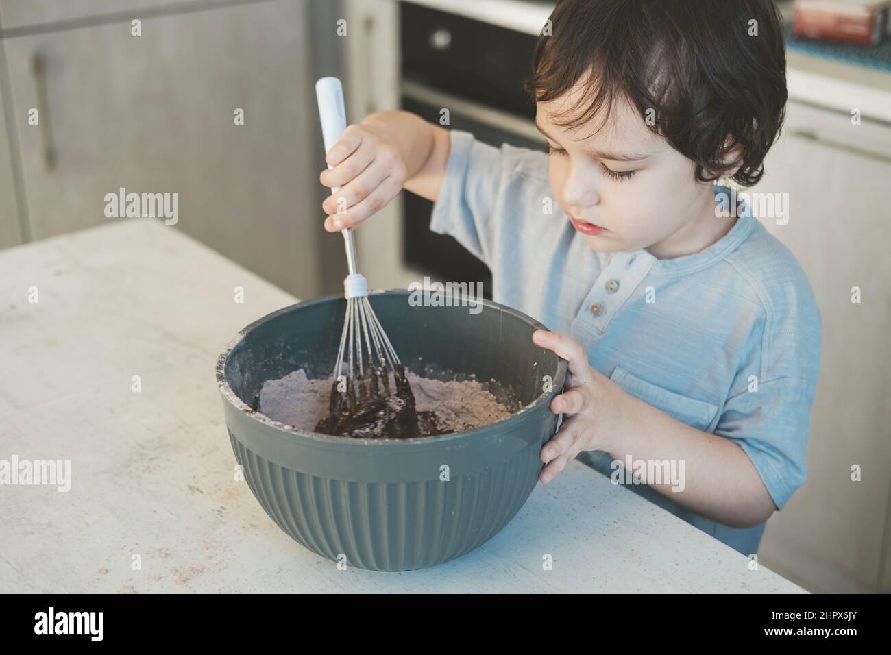 A little boy is cooking in the kitchen Stock Photo - Alamy