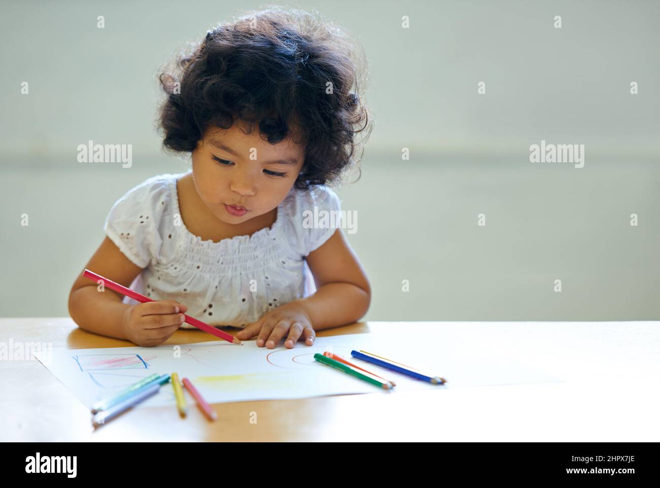 Learning as she grows. Shot of a cute little girl at home Stock Photo ...
