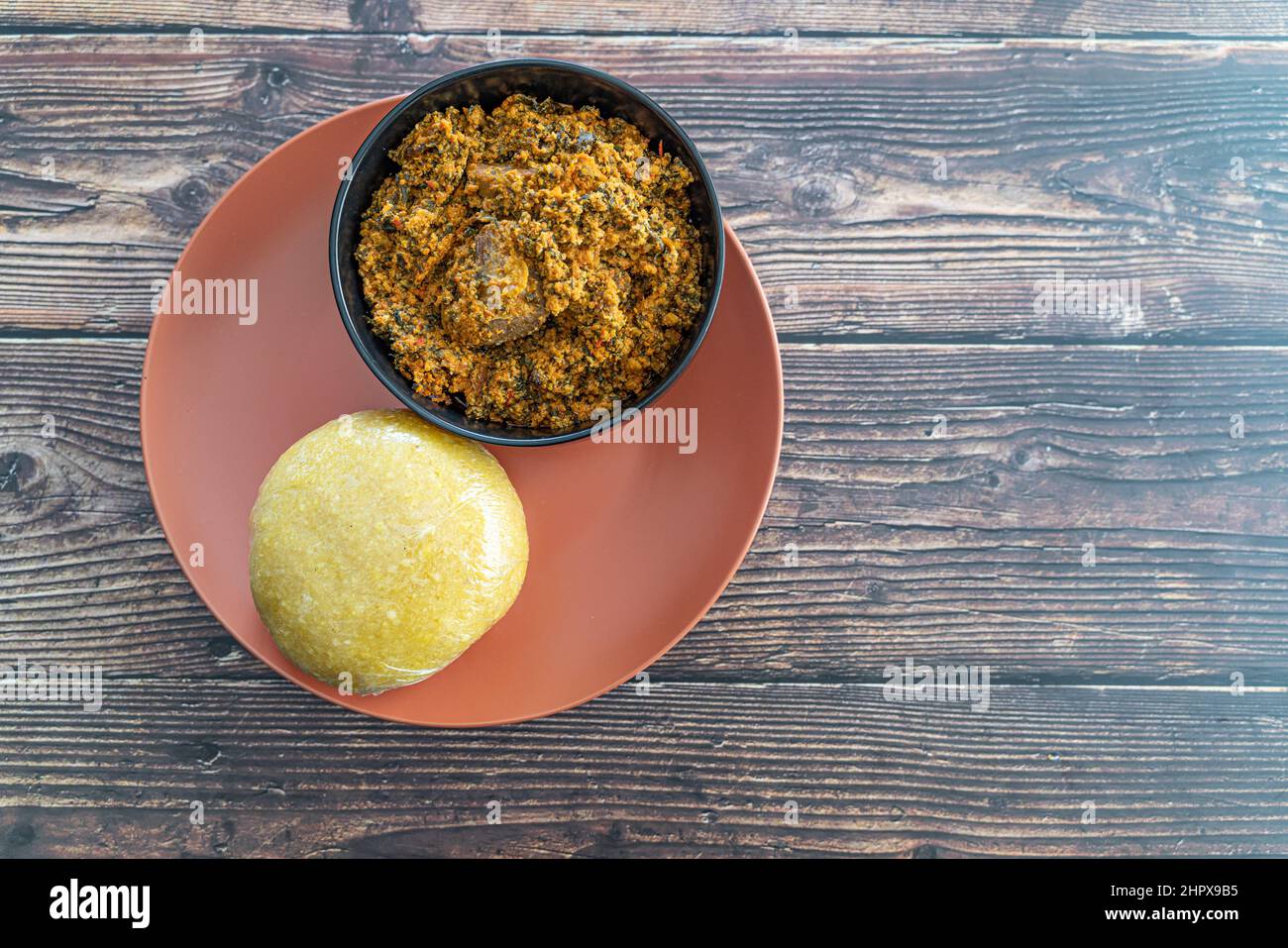 Nigerian Eba or Garrie Served with Egusi Soup for lunch Stock Photo - Alamy