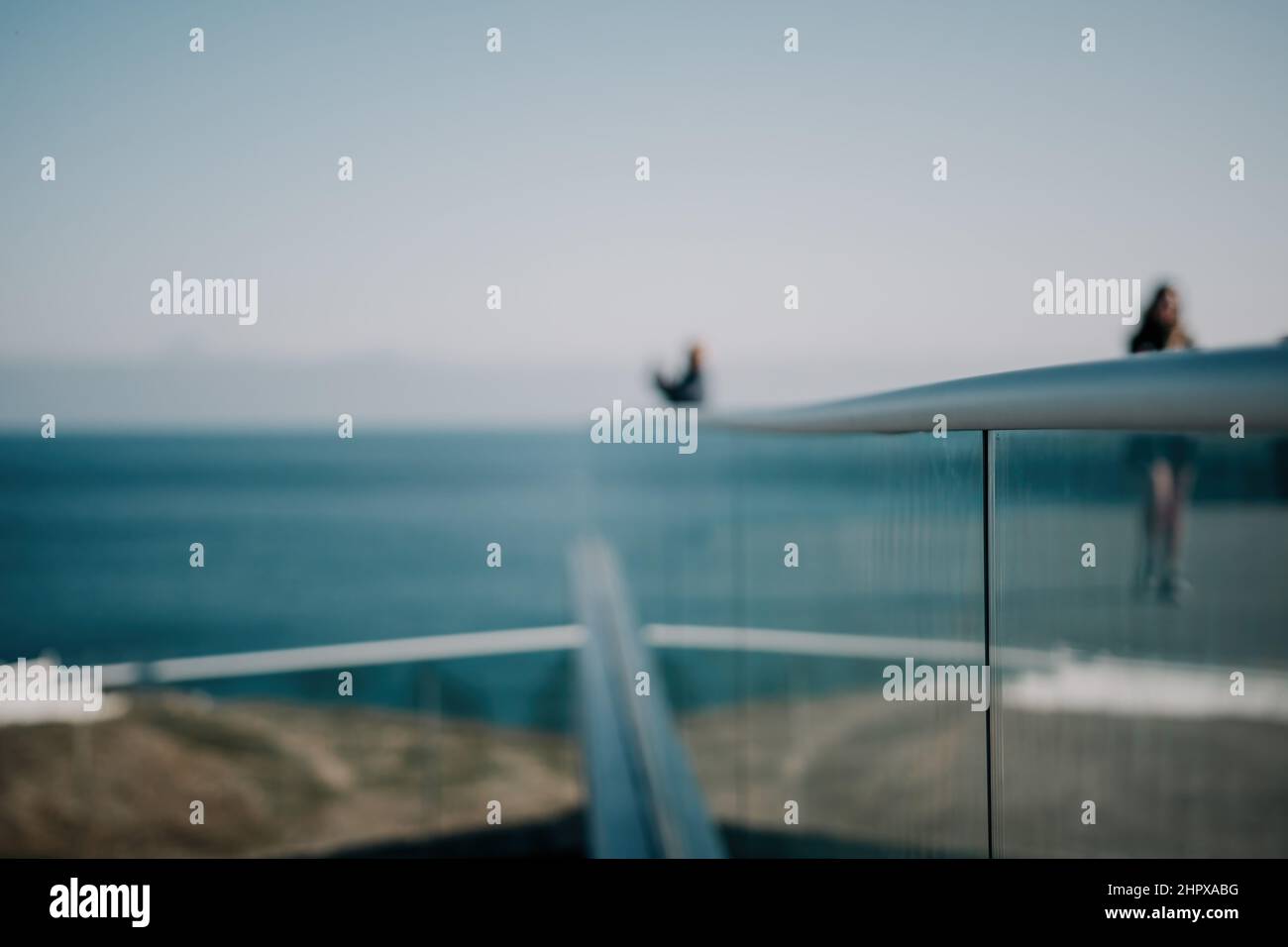 Abstract selective focus glass fence in the seaside park. a popular ...