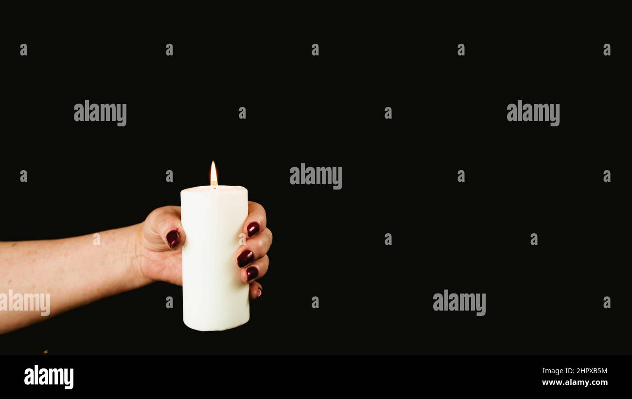 Crop person with burning candle. Crop anonymous person demonstrating ...