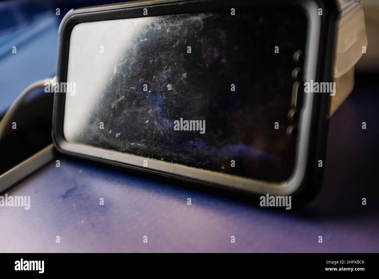 Scratched and dirty black phone screen close up still Stock Photo - Alamy