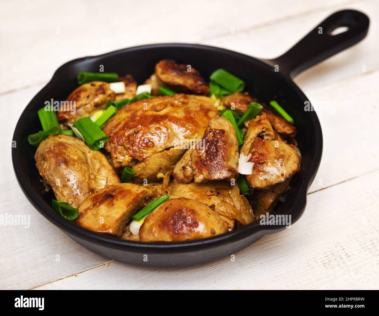 Fried duck liver with green onions Stock Photo - Alamy