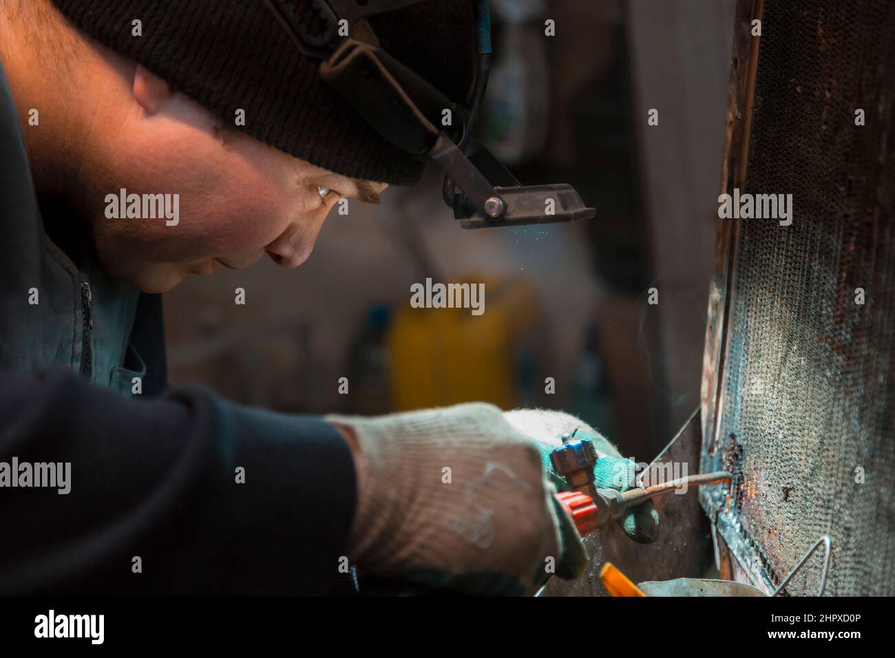 Welding a large car radiator with a gas torch Stock Photo - Alamy