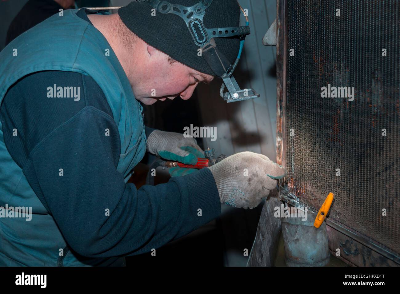 Welding a large car radiator with a gas torch Stock Photo - Alamy