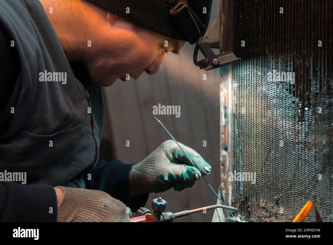 Welding a large car radiator with a gas torch Stock Photo - Alamy