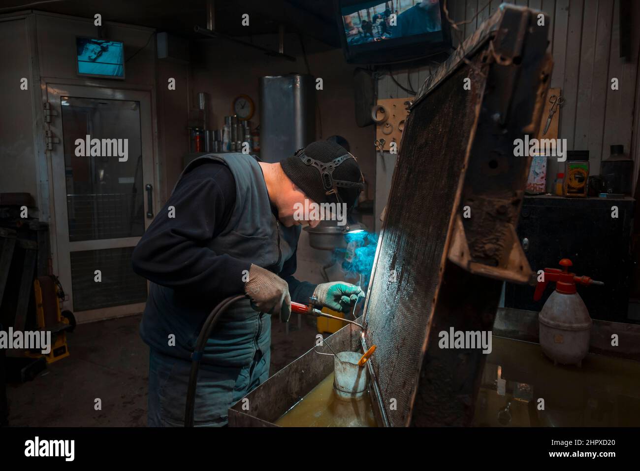 Welding a large car radiator with a gas torch Stock Photo - Alamy