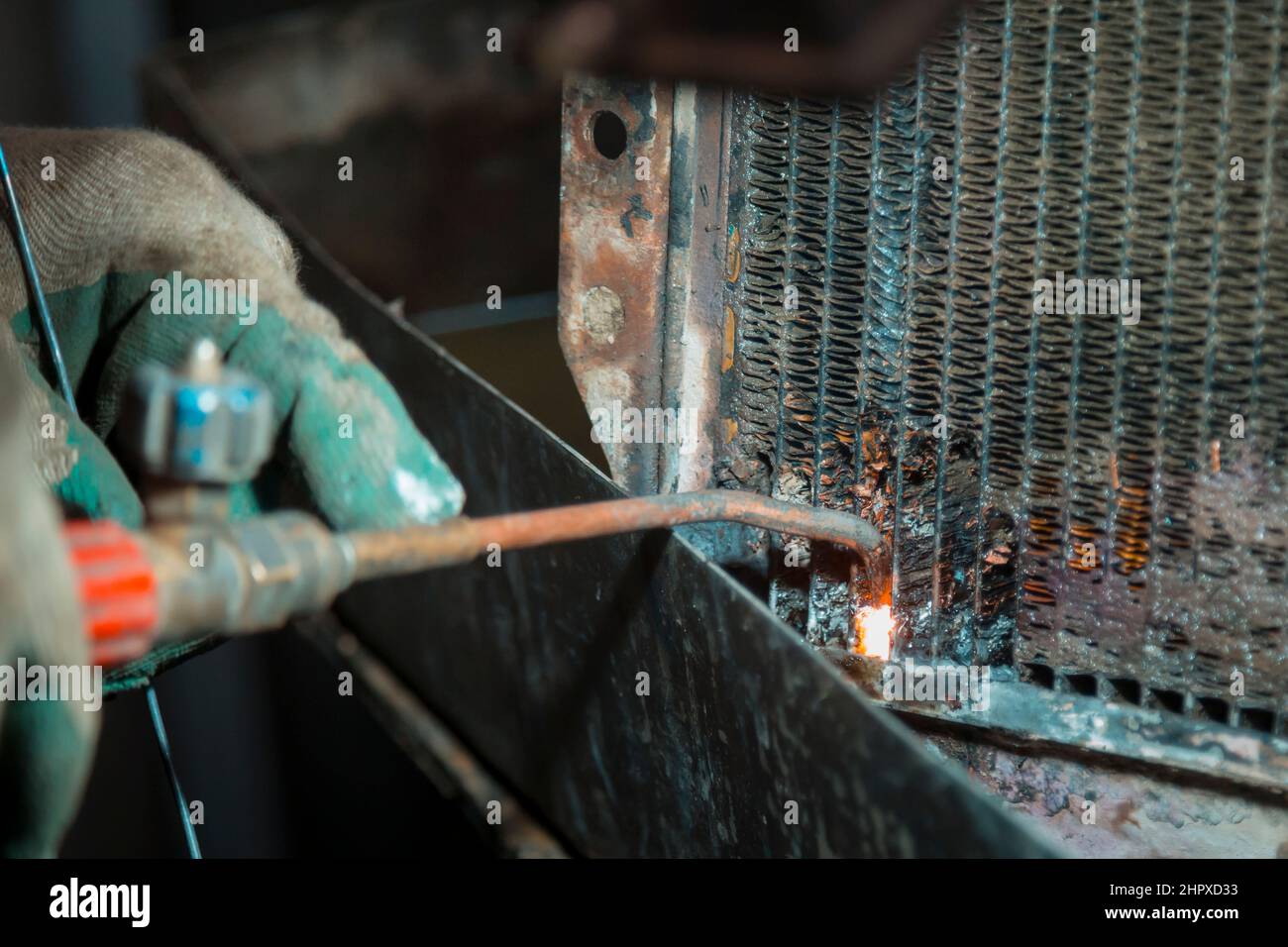 Welding a large car radiator with a gas torch Stock Photo - Alamy