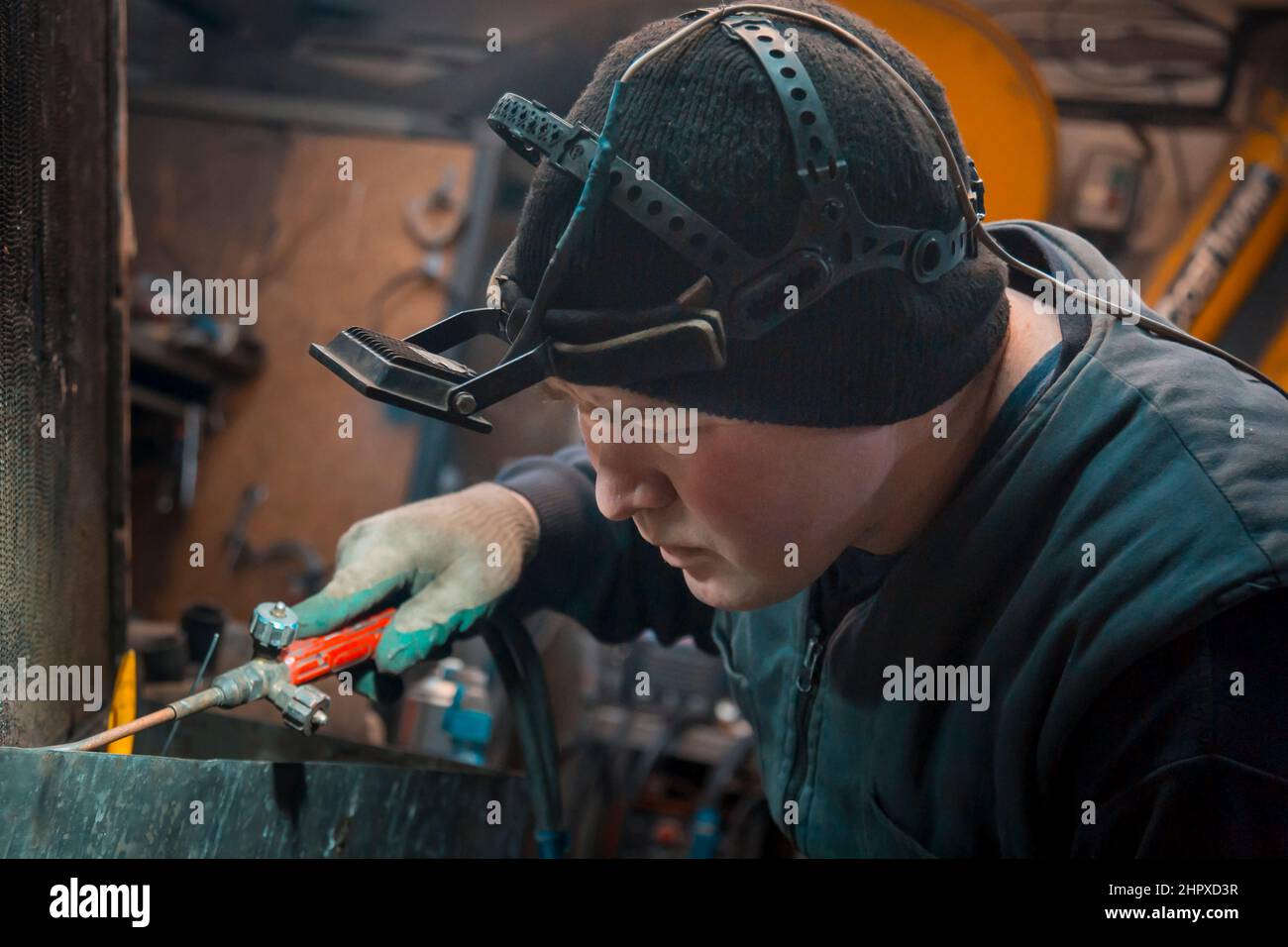 Welding a large car radiator with a gas torch Stock Photo - Alamy
