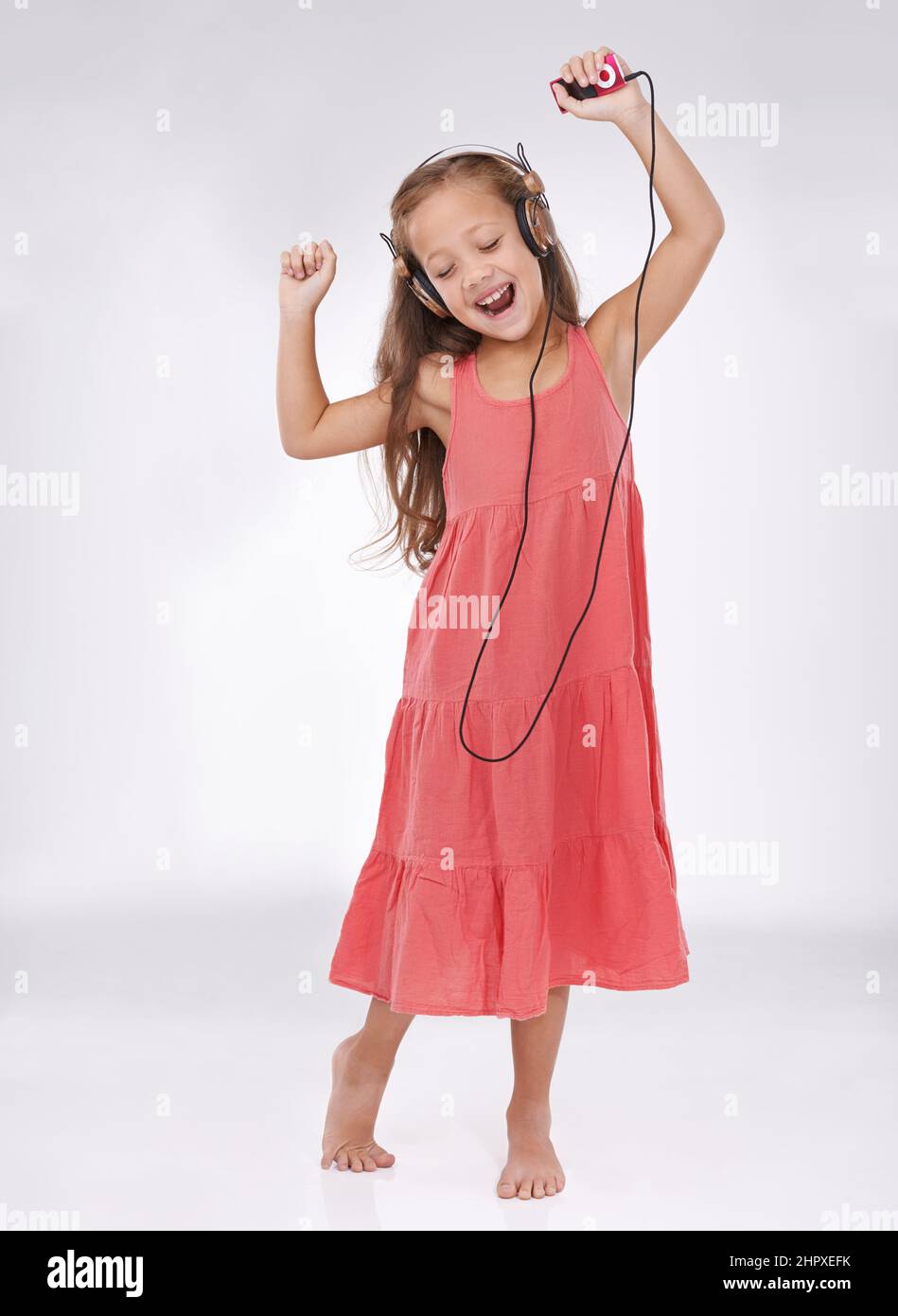 Shes a very musical child. A young girl listening to music on her head ...