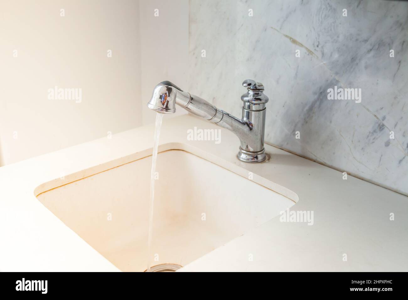 Water drop from faucet white modern white sink Stock Photo - Alamy