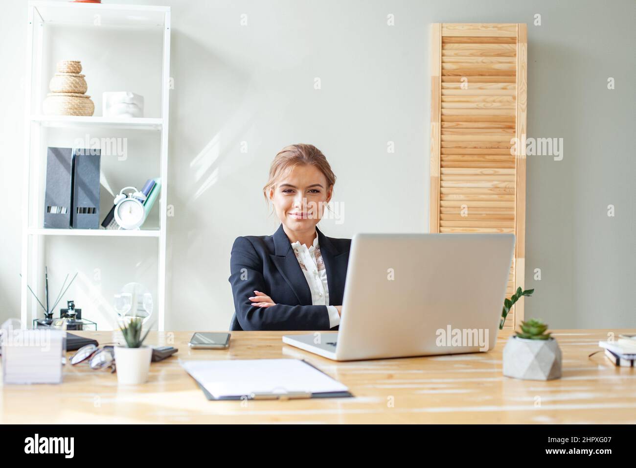 Successful businesswoman sitting desk office arms crossed hi-res stock ...