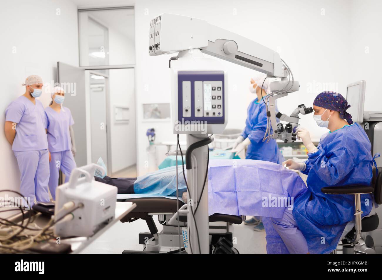 A team of medical staff and doctors working on a patient in a operating ...