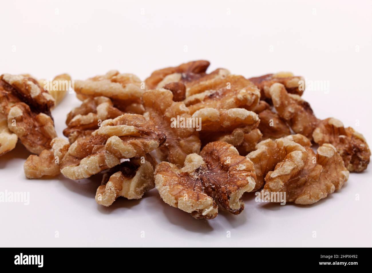 a pile of walnuts on a white background Stock Photo - Alamy