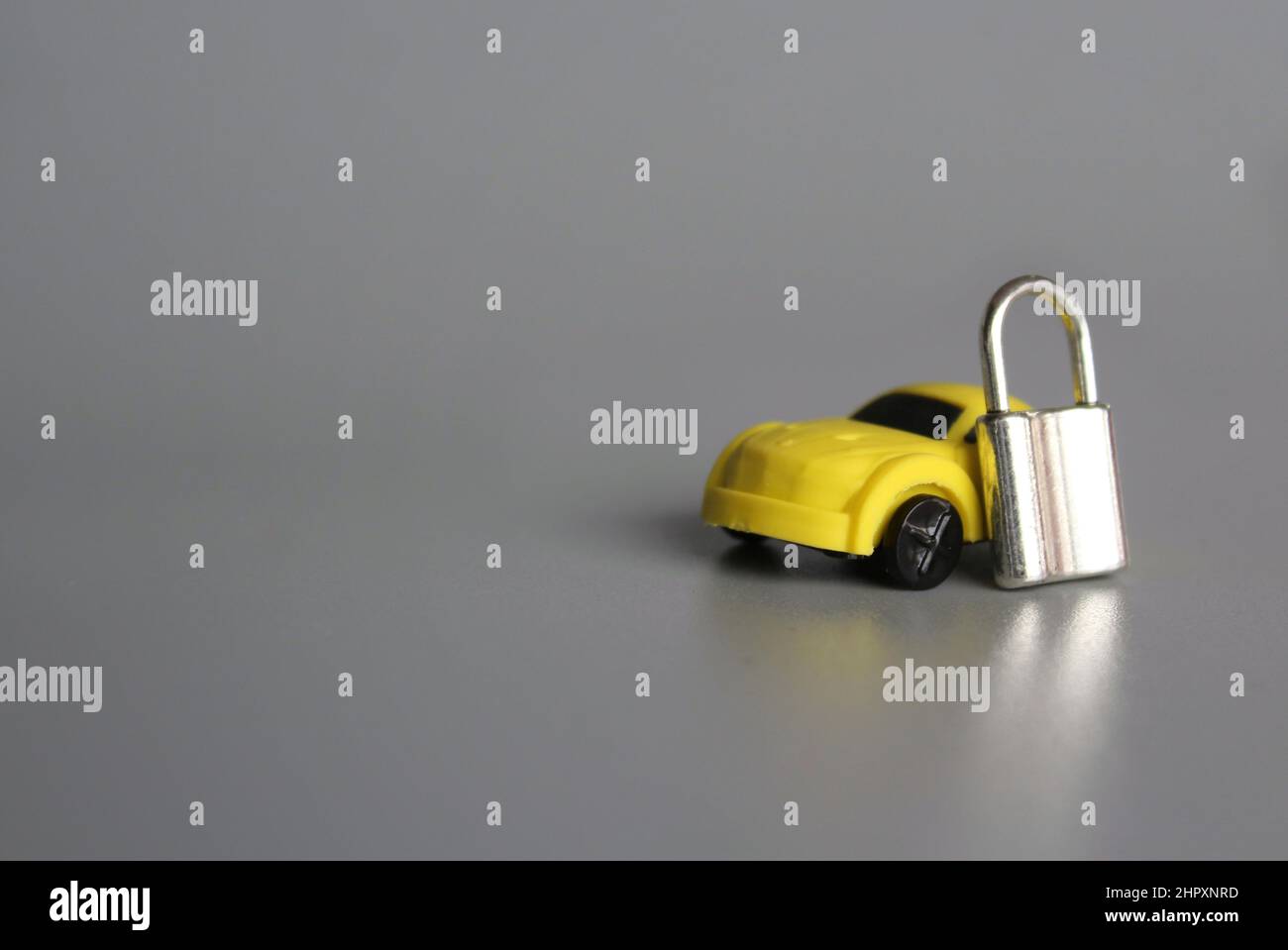 Car security, insurance and theft protection concept. Toy car and ...