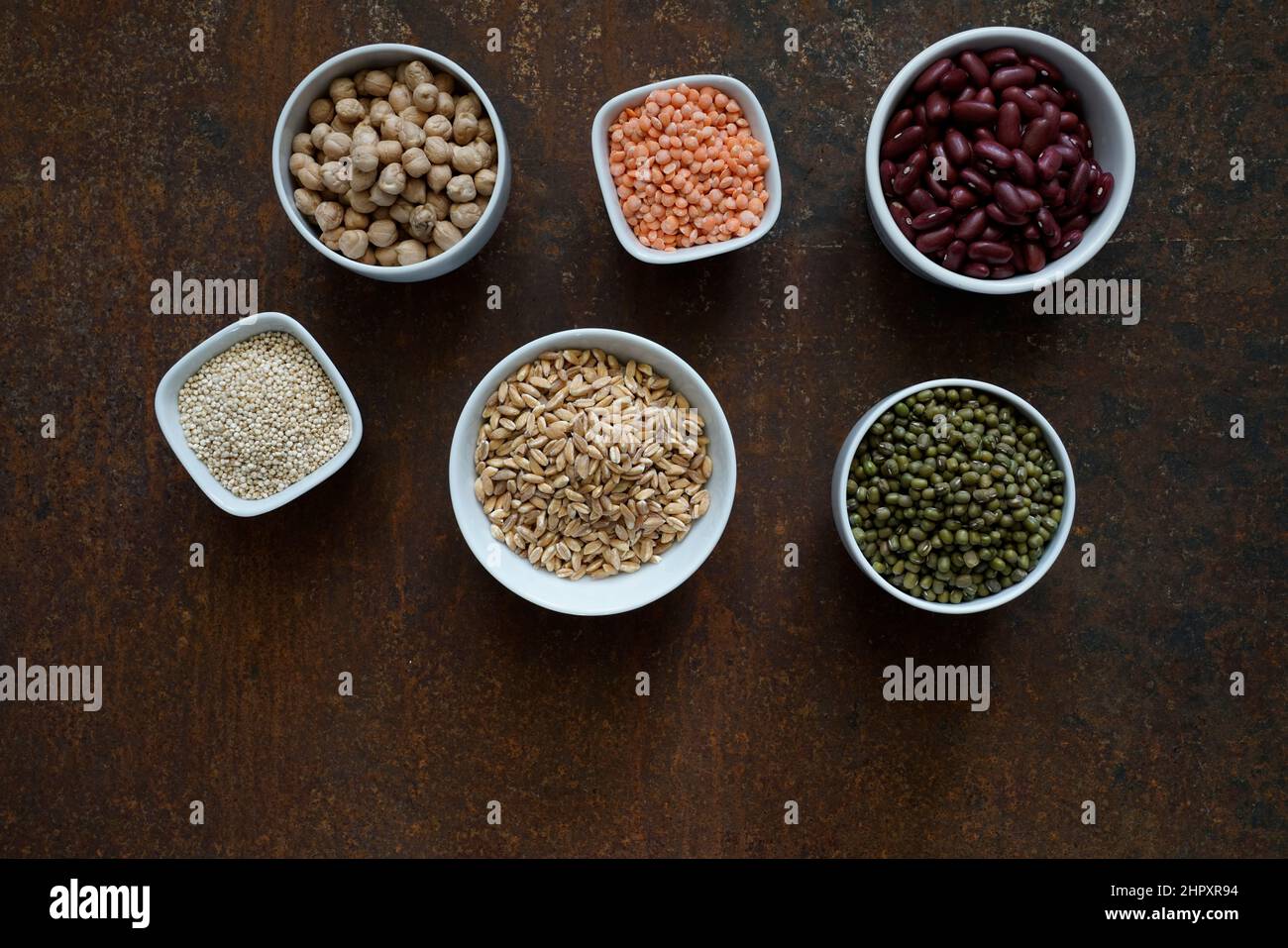 Variety of uncooked superfood cereals, chia, red lentils, pearl spelled ...