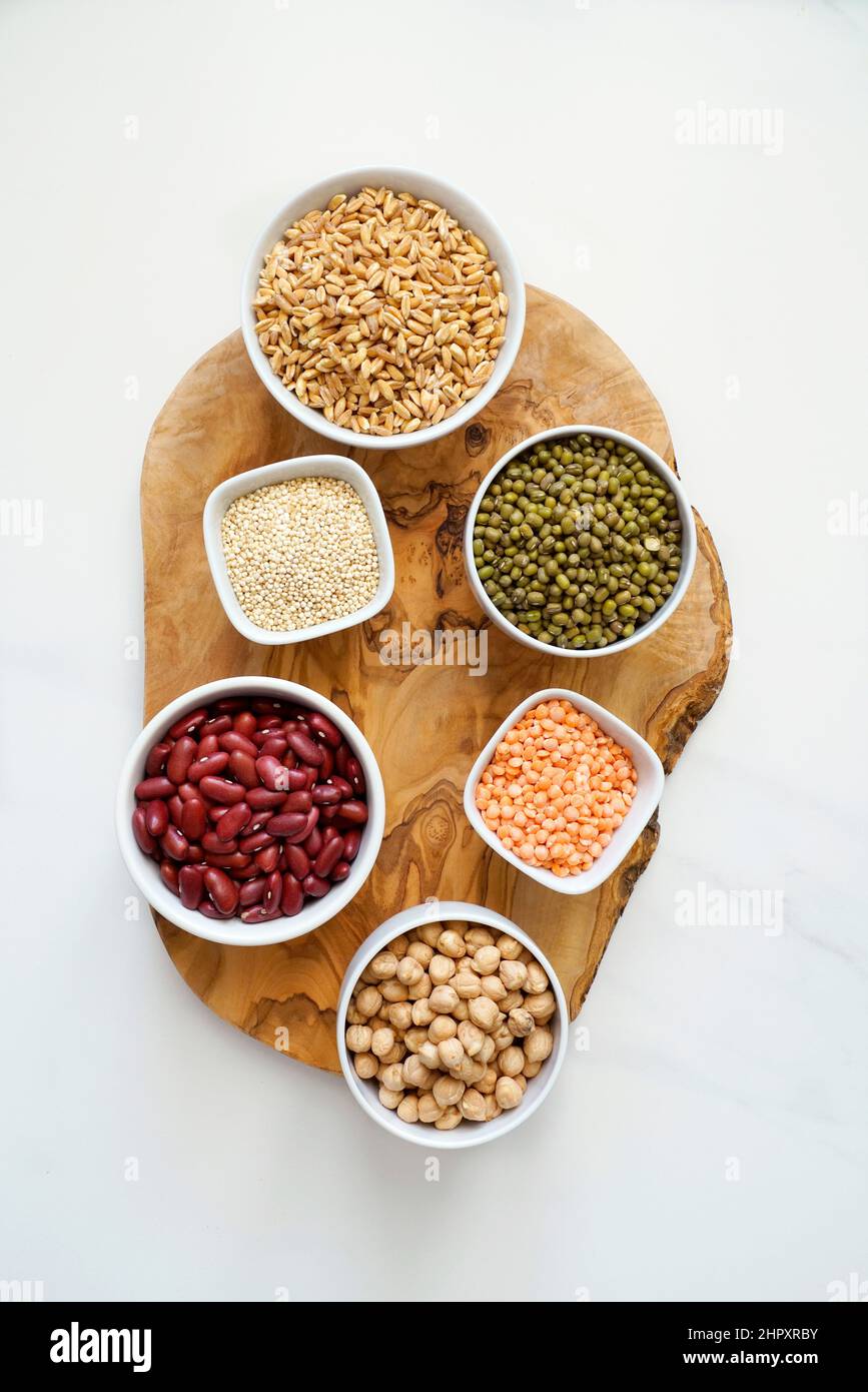 Variety of uncooked superfood cereals, chia, red lentils, pearl spelled ...