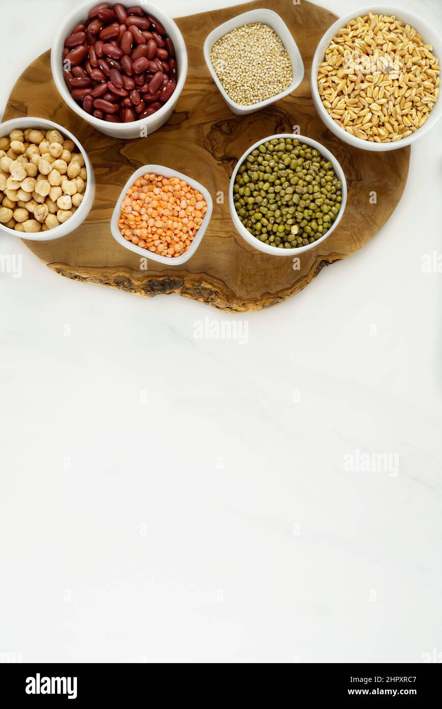 Variety of uncooked superfood cereals, chia, red lentils, pearl spelled ...
