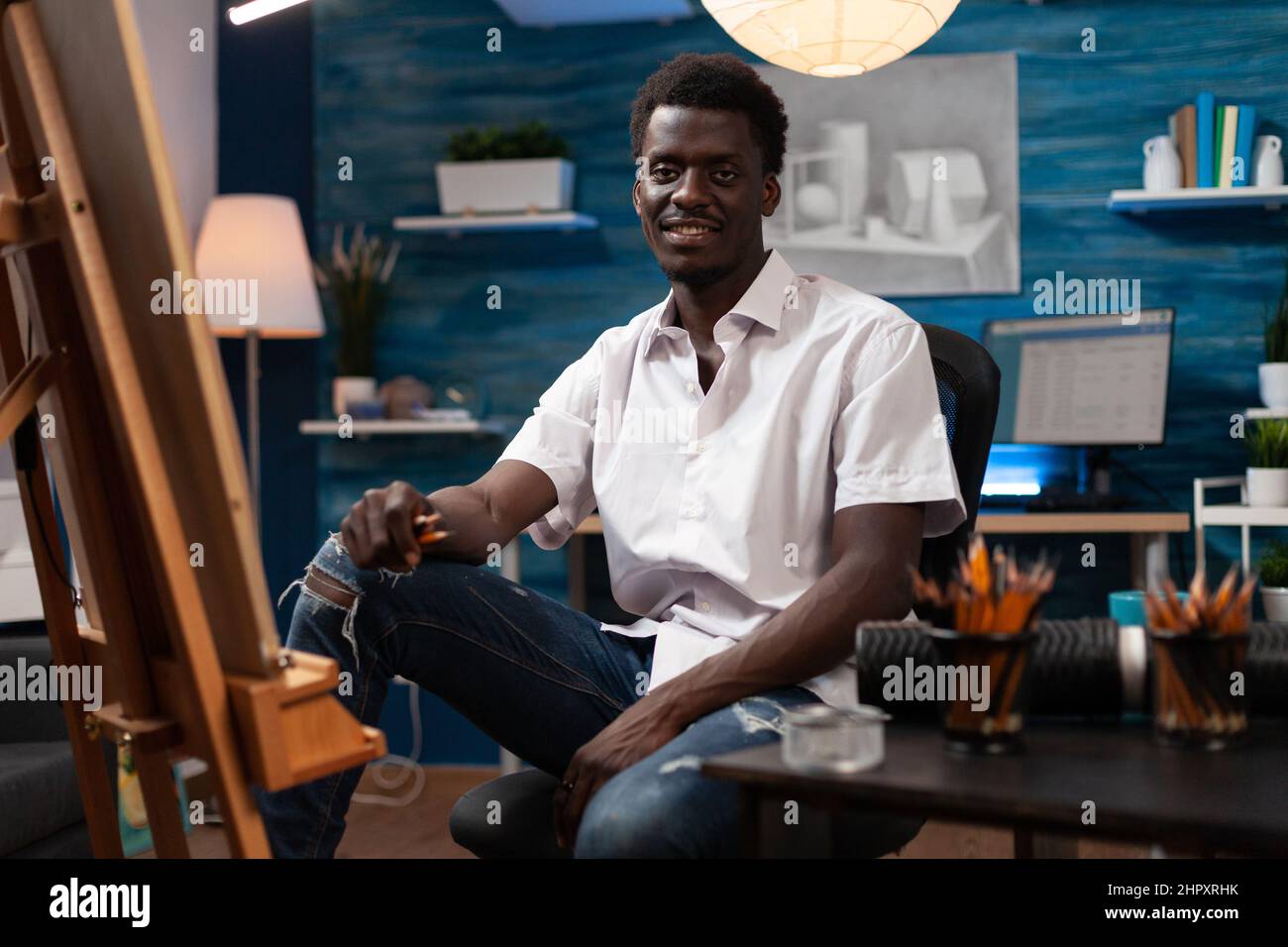 Portrait of smiling man artist smiling holding graphic pencil for ...