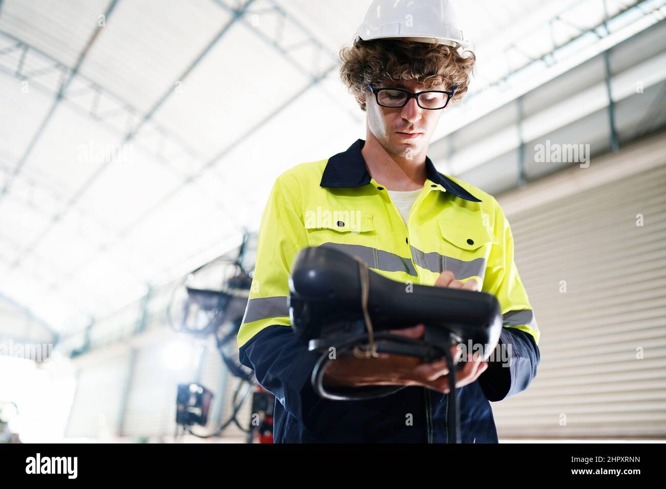 engineer checking control panel and teaching new Automatics robot arm ...