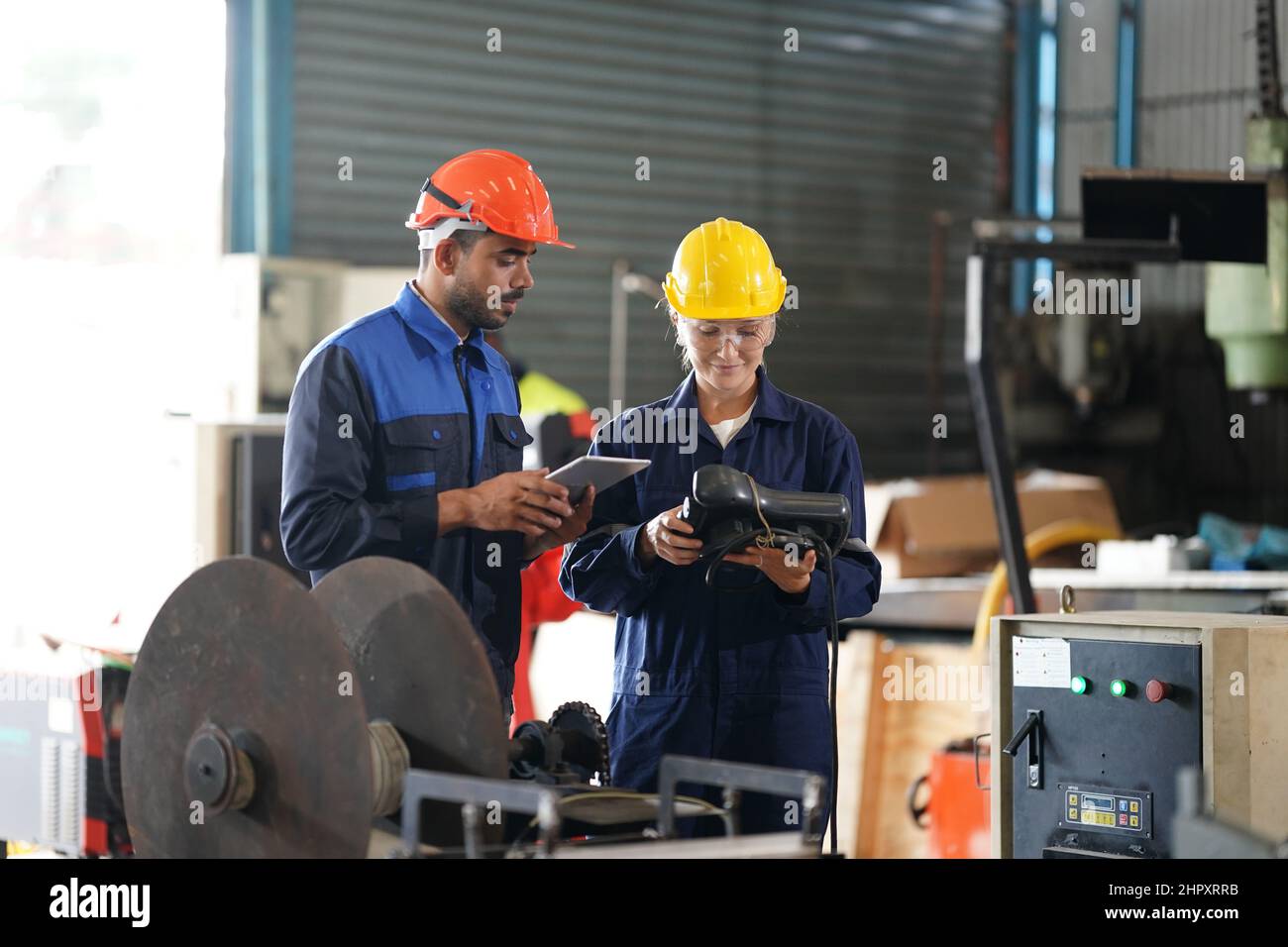 engineer checking control panel and teaching new Automatics robot arm ...