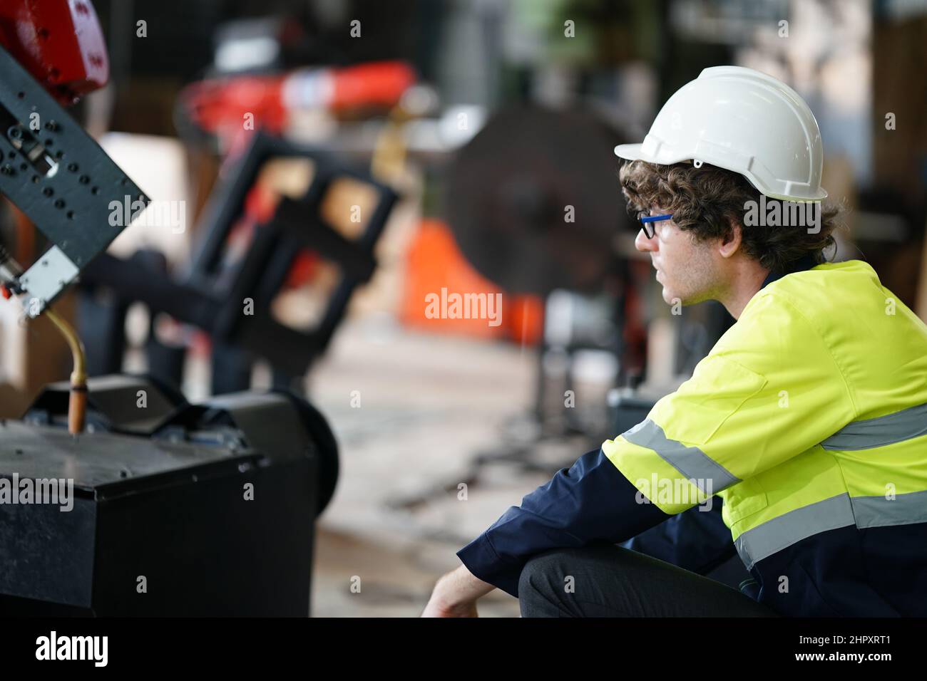 engineer checking control panel and teaching new Automatics robot arm ...